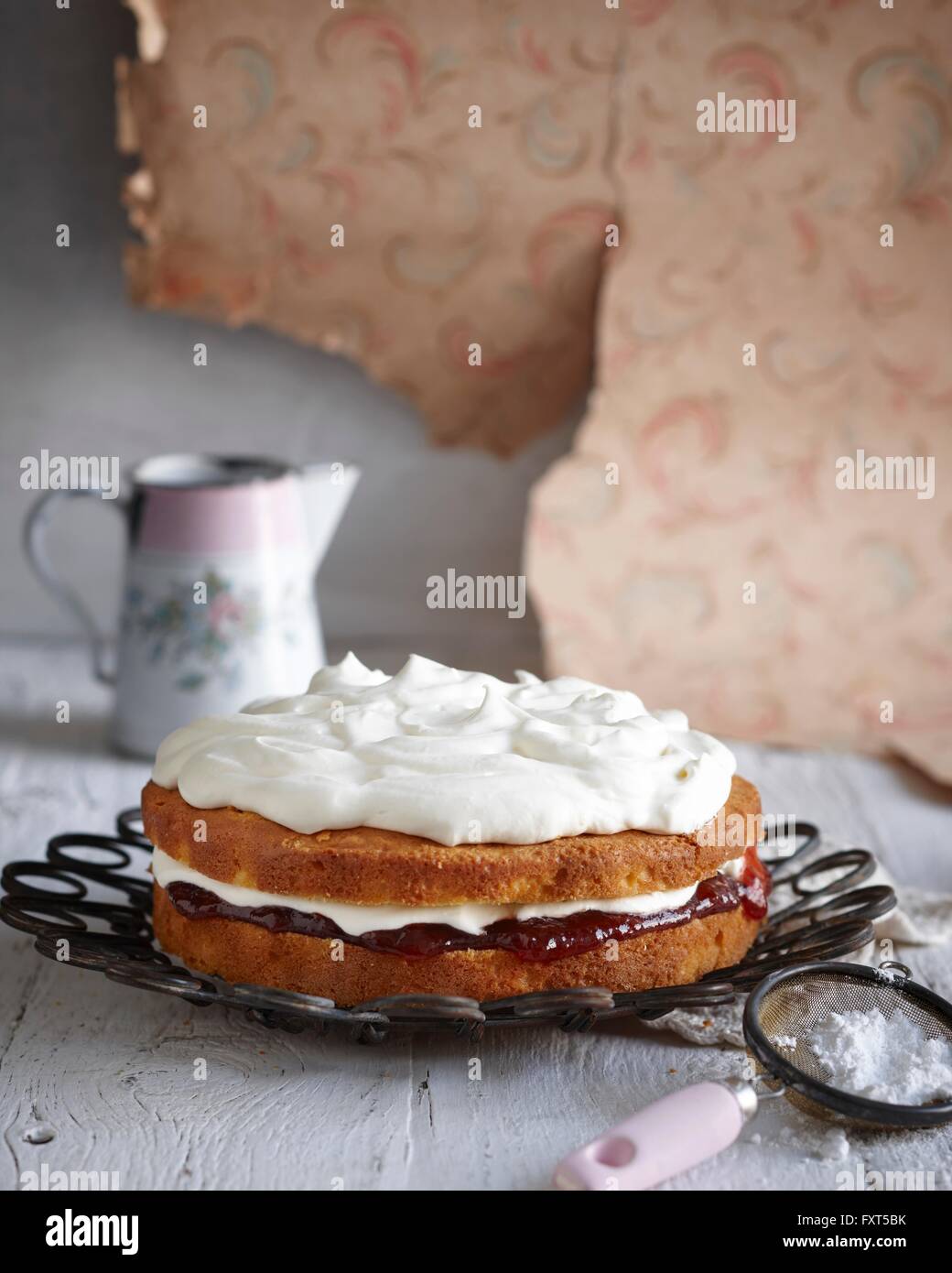 Iced sponge custard cake on vintage dish Stock Photo - Alamy