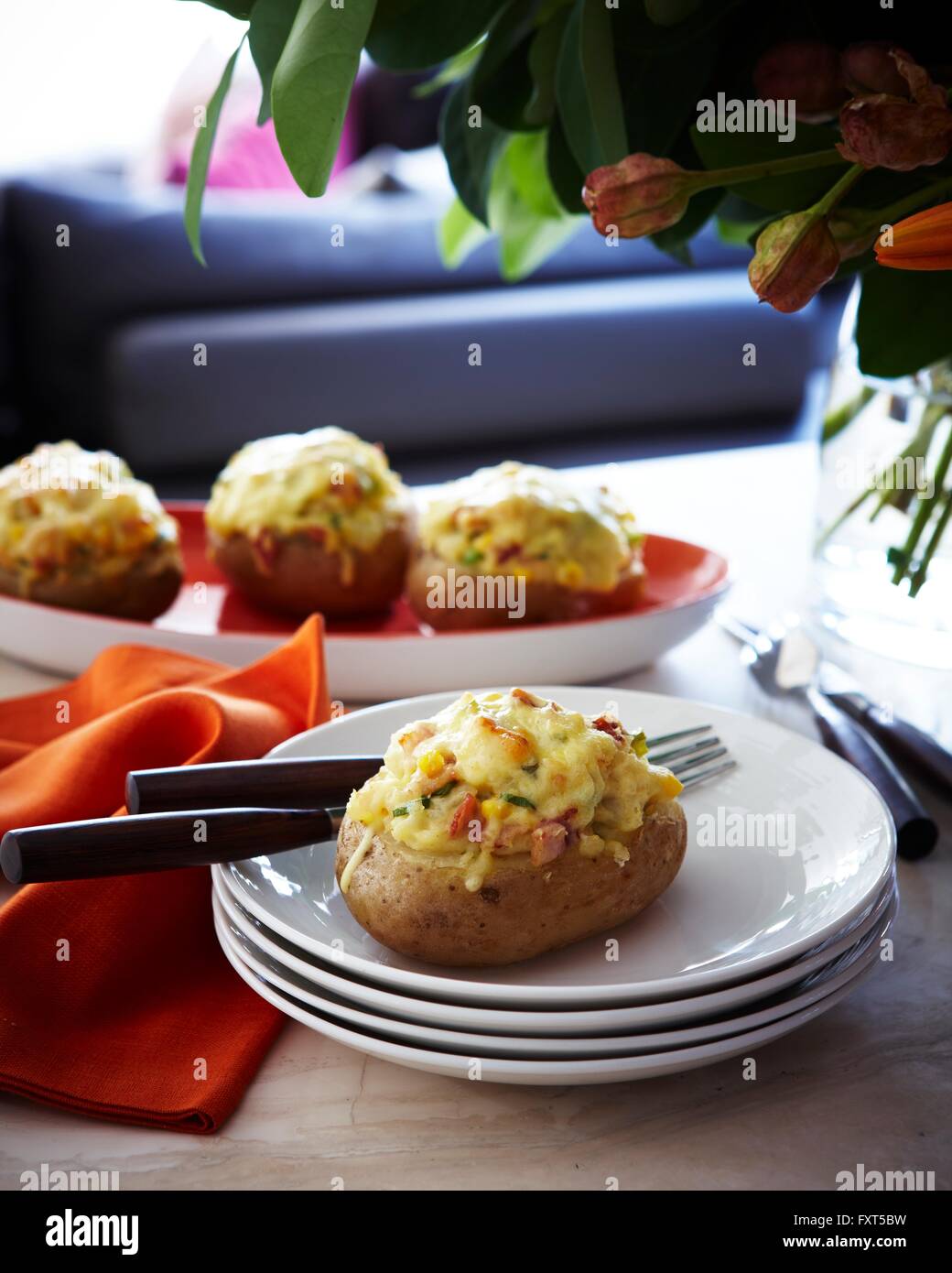 Plates with stuffed baked potatoes on table Stock Photo - Alamy