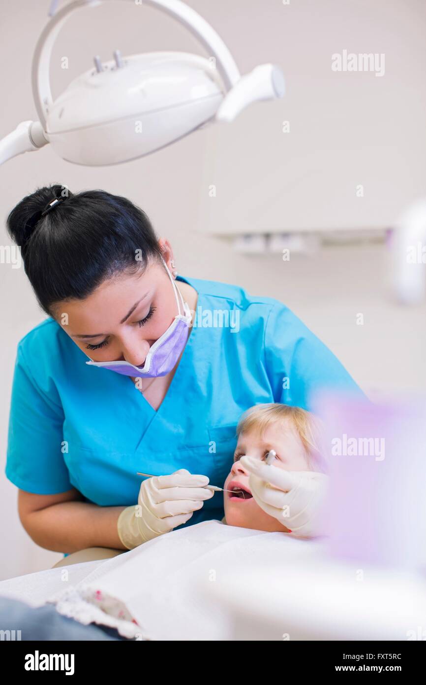 Girl in dentist chair having dental examination Stock Photo - Alamy