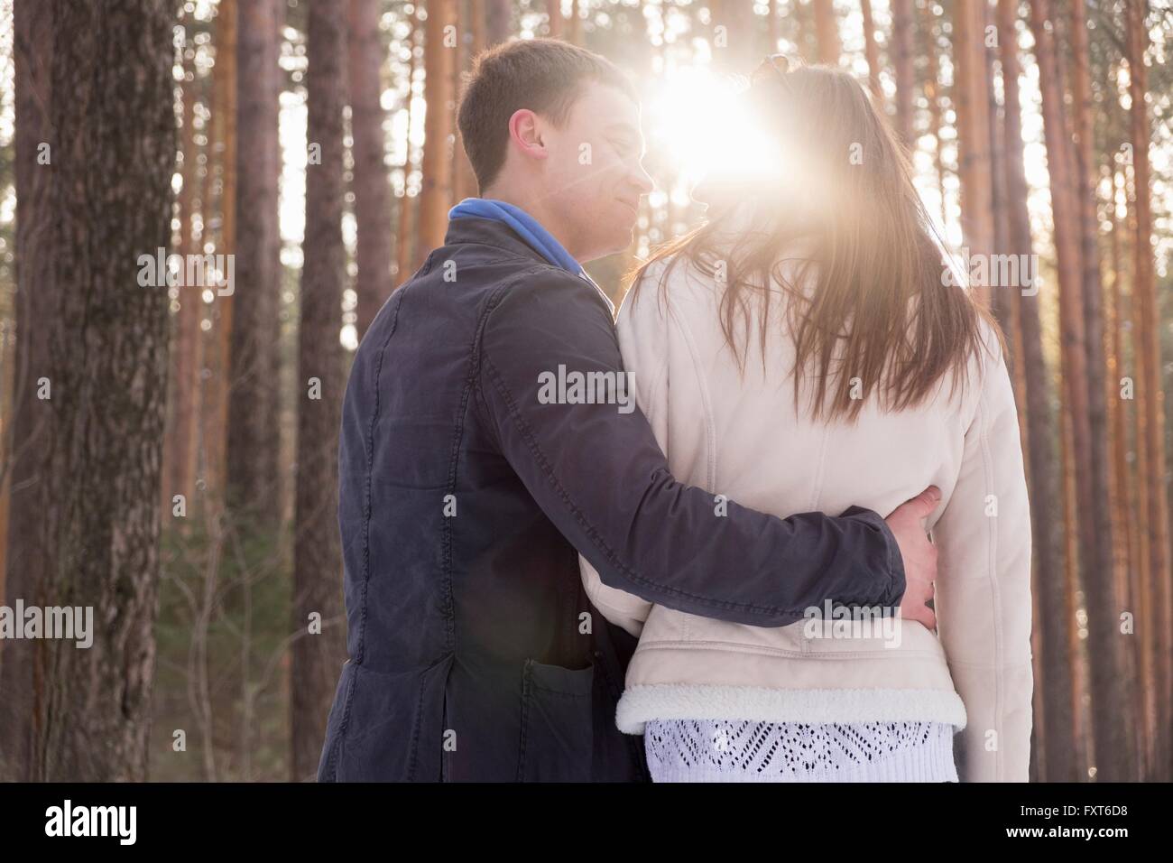 Young man guiding woman in forest Stock Photo - Alamy