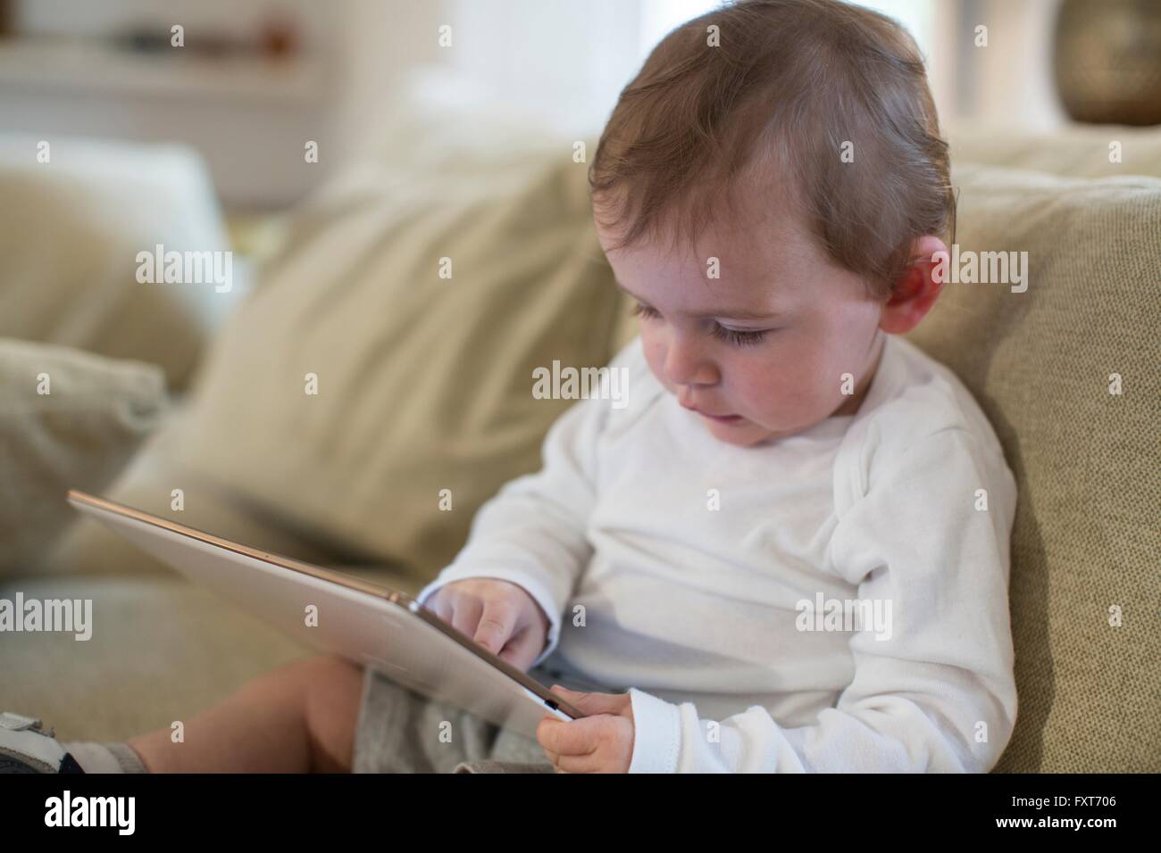 Baby boy using digital tablet Stock Photo - Alamy