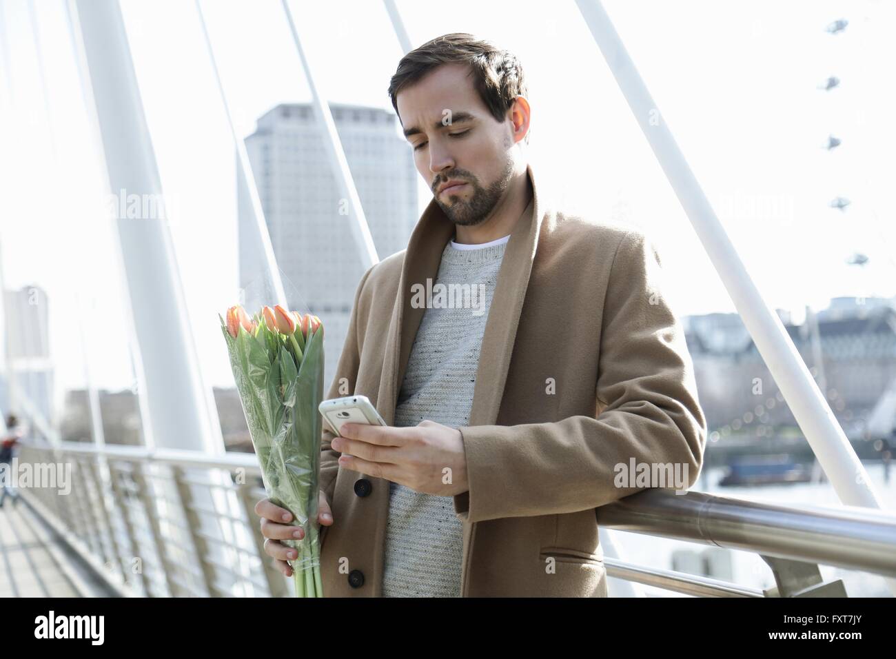 Man waiting on bridge holding flowers hi-res stock photography and ...