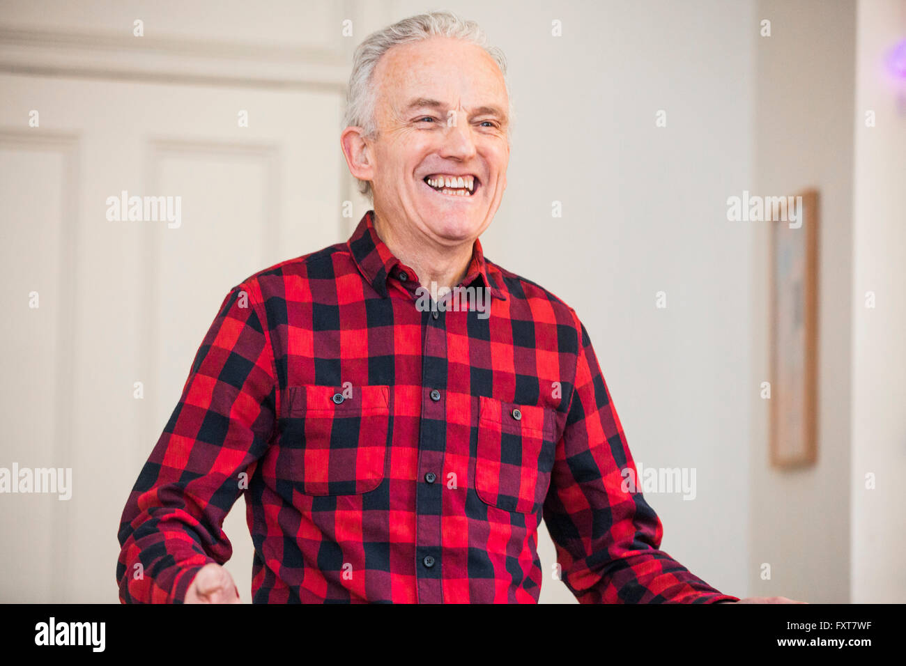 Portrait of happy senior man wearing red checked shirt Stock Photo - Alamy