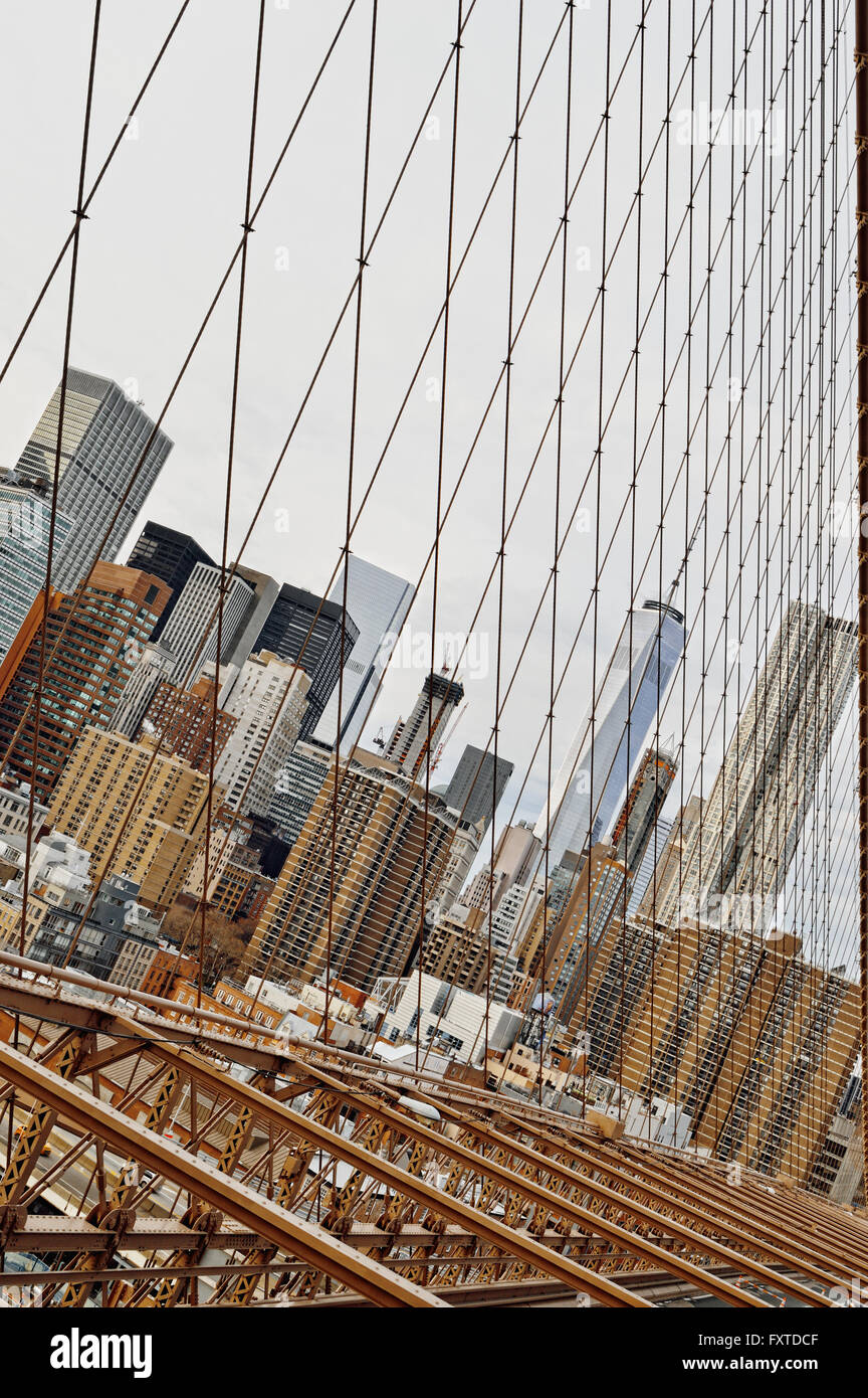 View of Manhattan through the wires of the Brooklyn Bridge Stock Photo ...