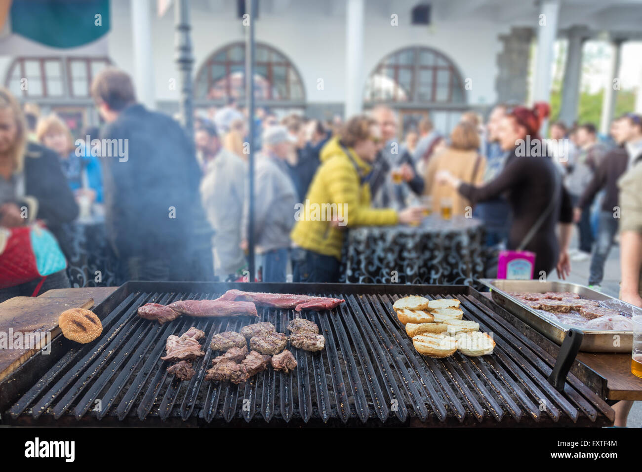 Beef burgers being grilled on food stall grill Stock Photo - Alamy