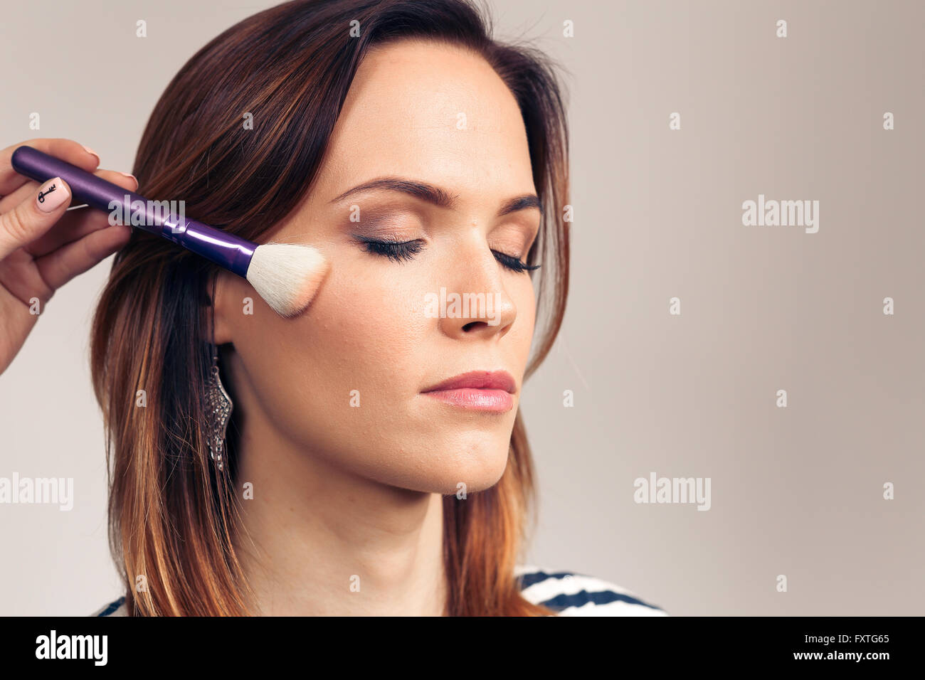 Closeup photo of cheek during professional makeup Stock Photo - Alamy