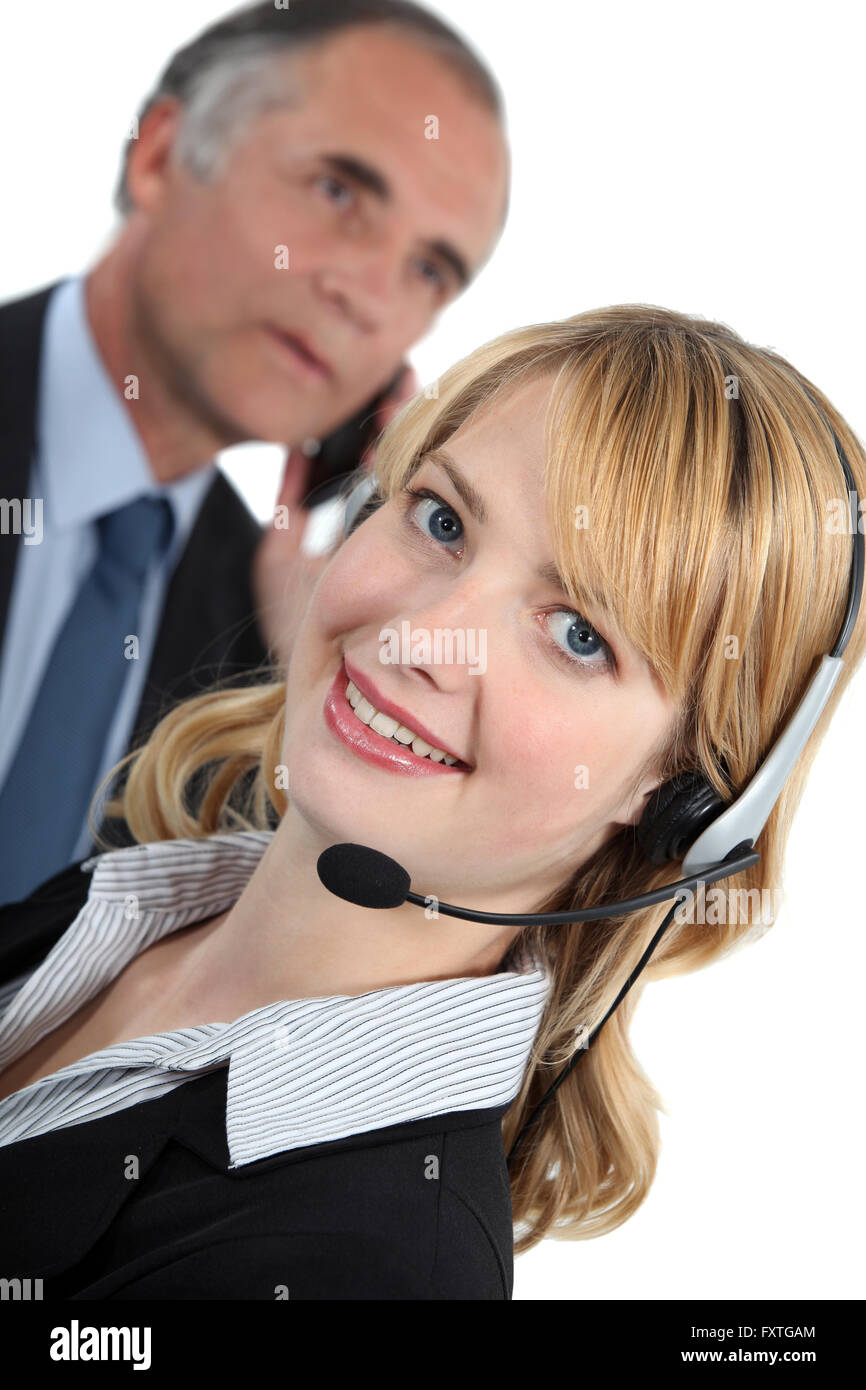 Young receptionist with headset Stock Photo - Alamy