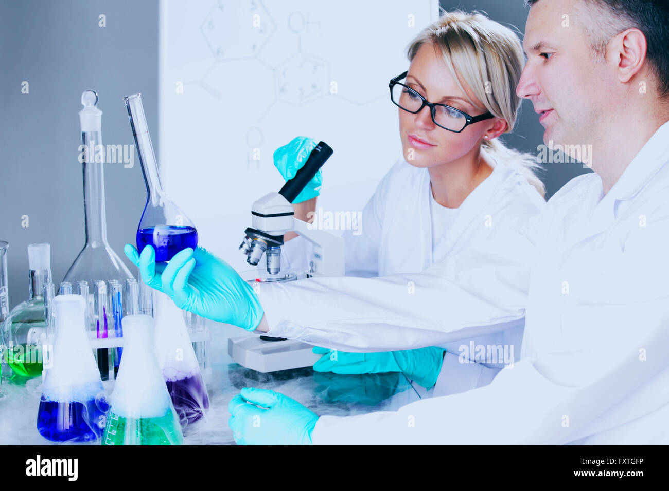 two scientist in chemical lab conducting experiments Stock Photo - Alamy