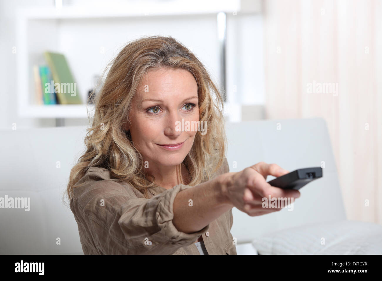 portrait of a woman with remote control Stock Photo - Alamy