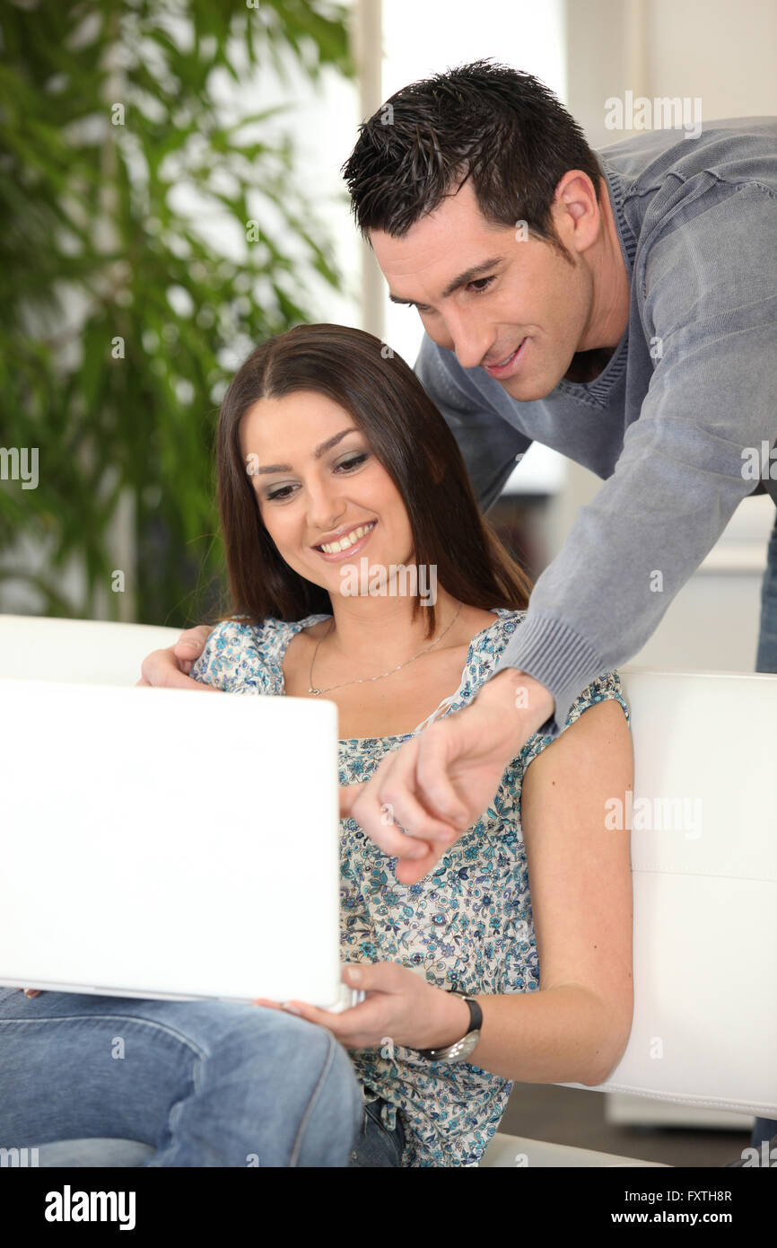 Couple having fun on the computer Stock Photo - Alamy