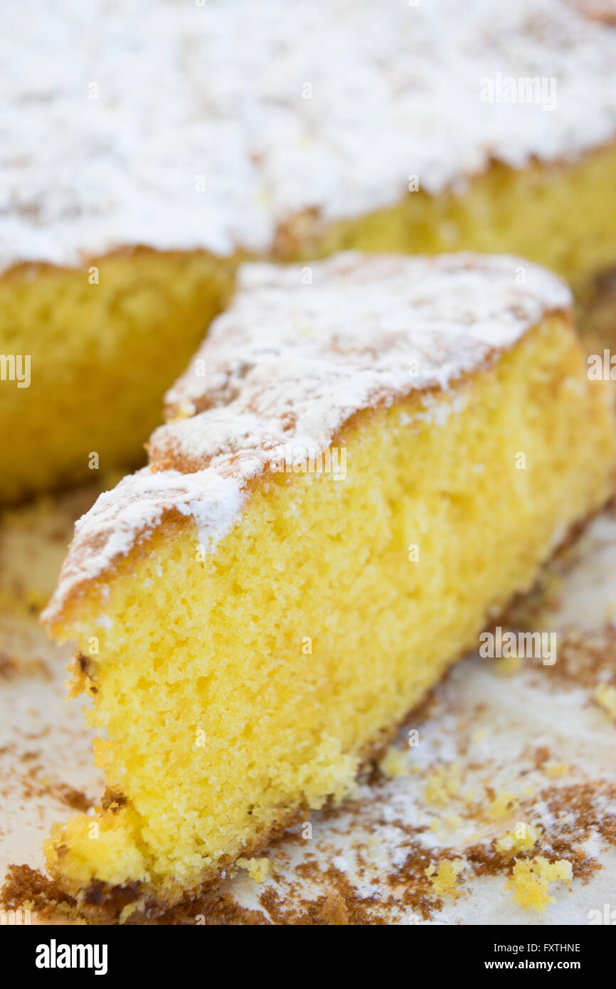 a slice of sponge cake with icing sugar Stock Photo - Alamy