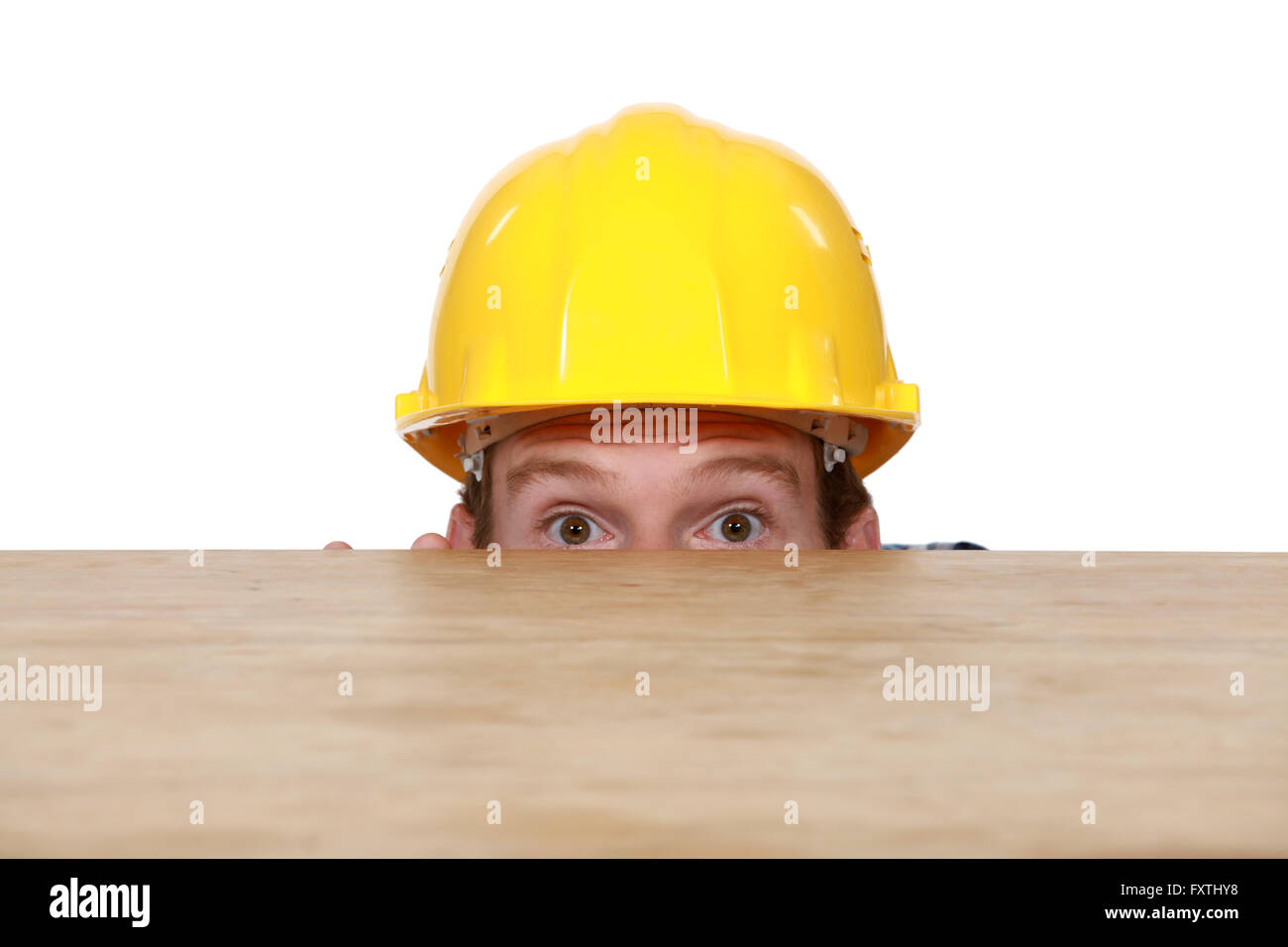 Man in a hardhat hiding Stock Photo - Alamy