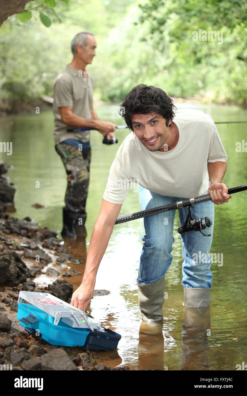 Men fishing in a river Stock Photo - Alamy