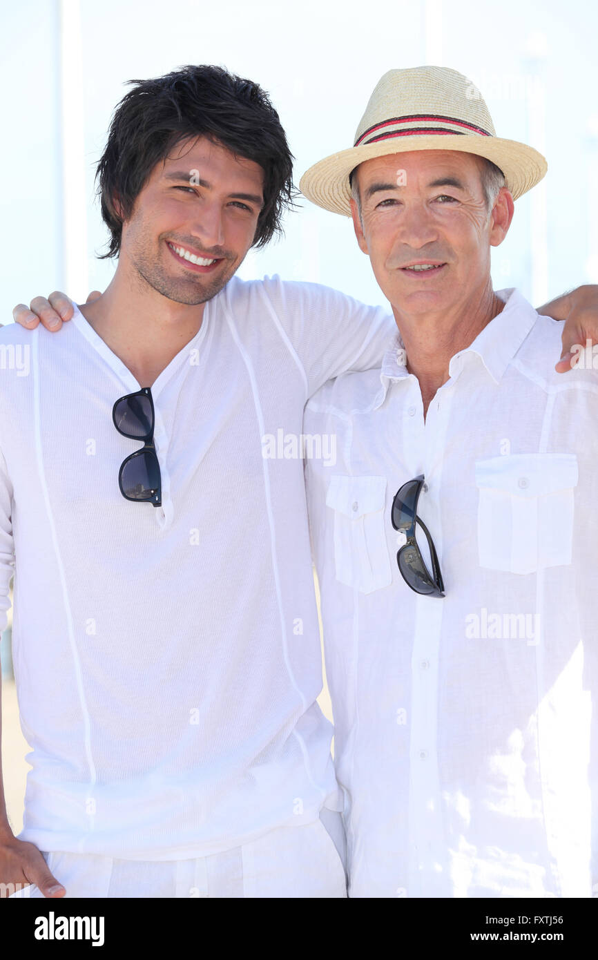 Grown up man standing with his father Stock Photo - Alamy