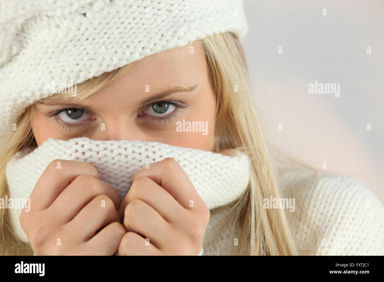 Woman covering her face with her sweater Stock Photo - Alamy