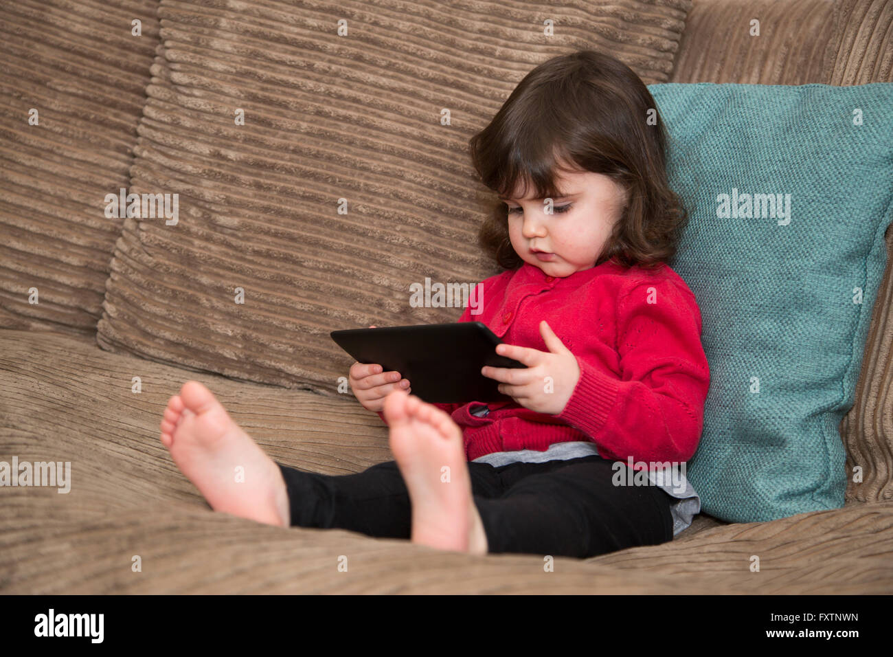 Toddler watching screen on tablet Stock Photo - Alamy