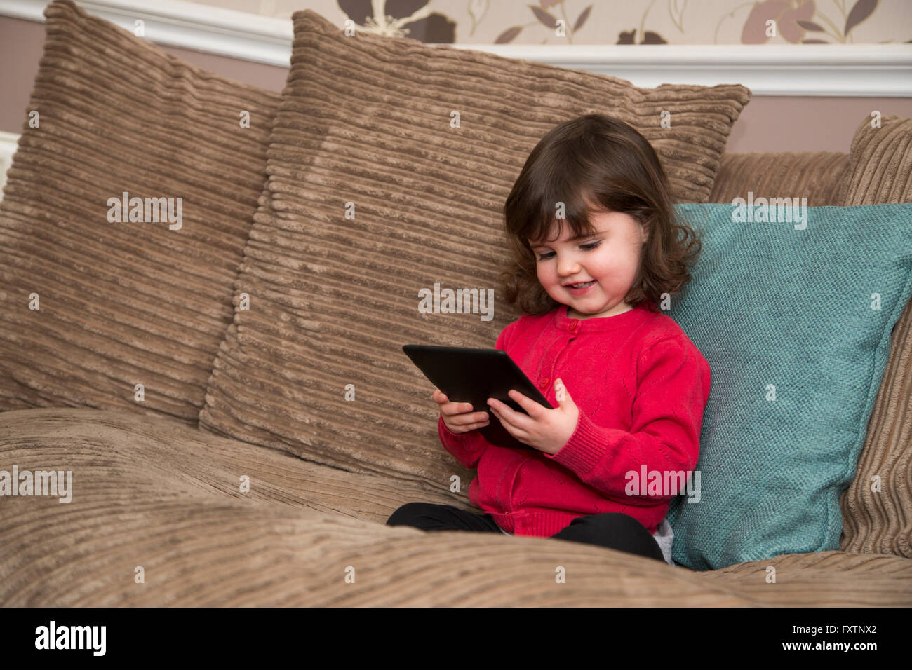 Enjoying watch the tablet Stock Photo - Alamy