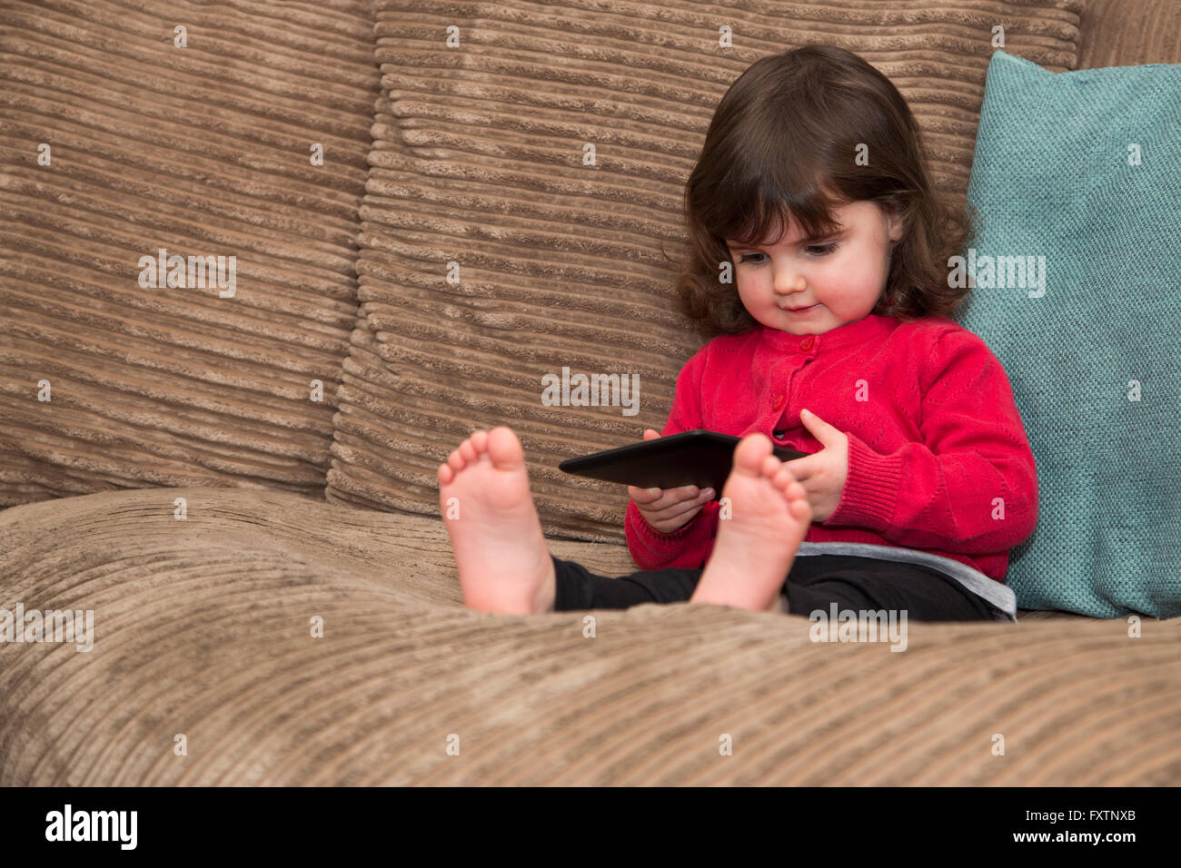 Toddler uses tablet PC Stock Photo - Alamy
