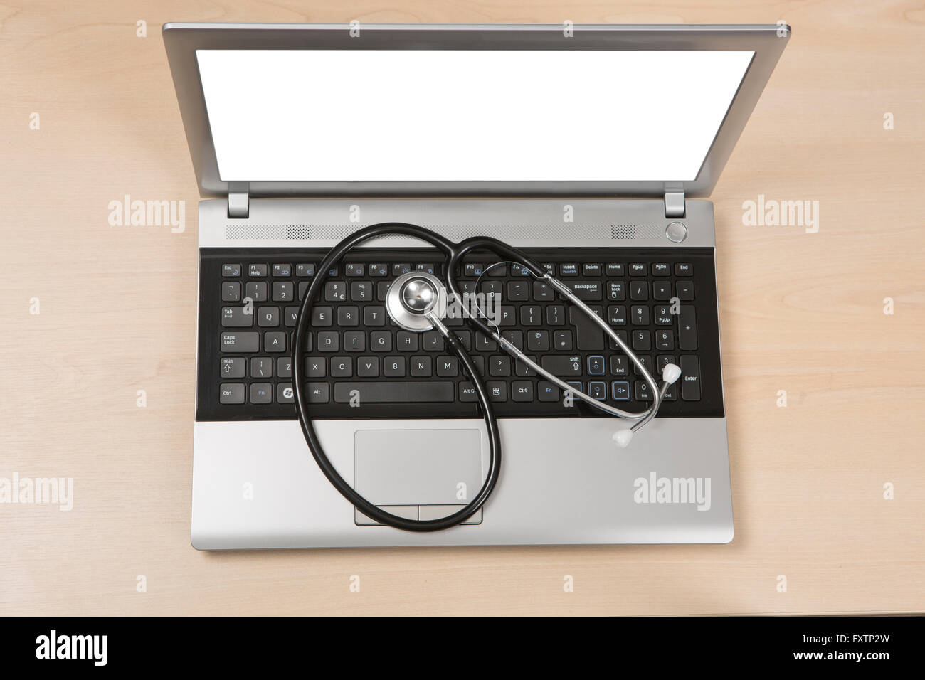 Doctors laptop with stethoscope on keyboard Stock Photo - Alamy