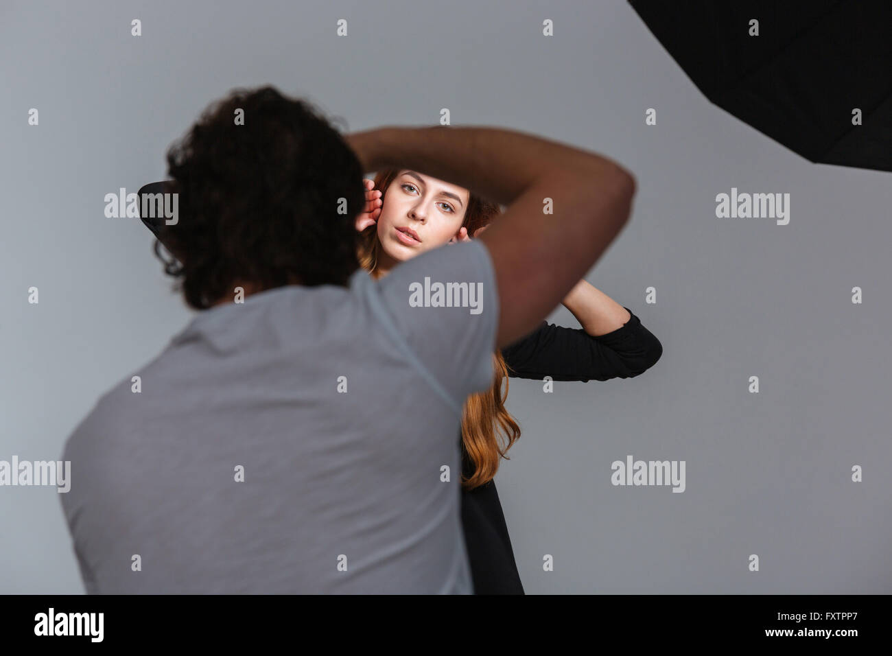 Photographer working with model in studio Stock Photo - Alamy