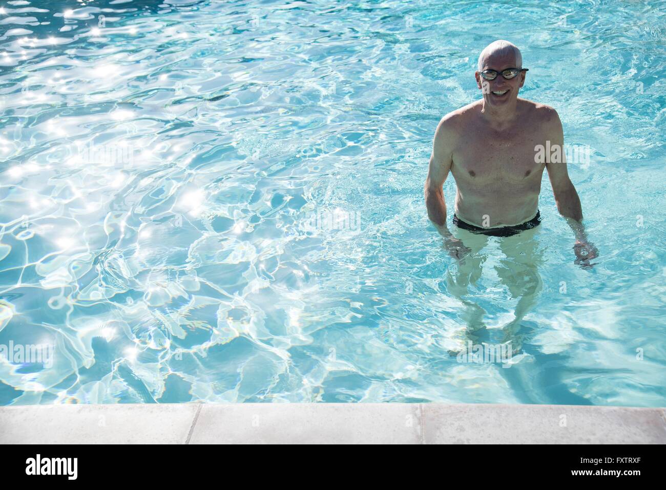 Senior man standing in outdoor swimming pool, smiling Stock Photo - Alamy