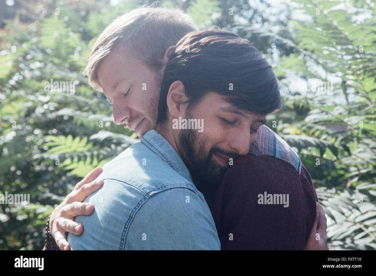 Smiling gay couple hugging hi-res stock photography and images - Alamy