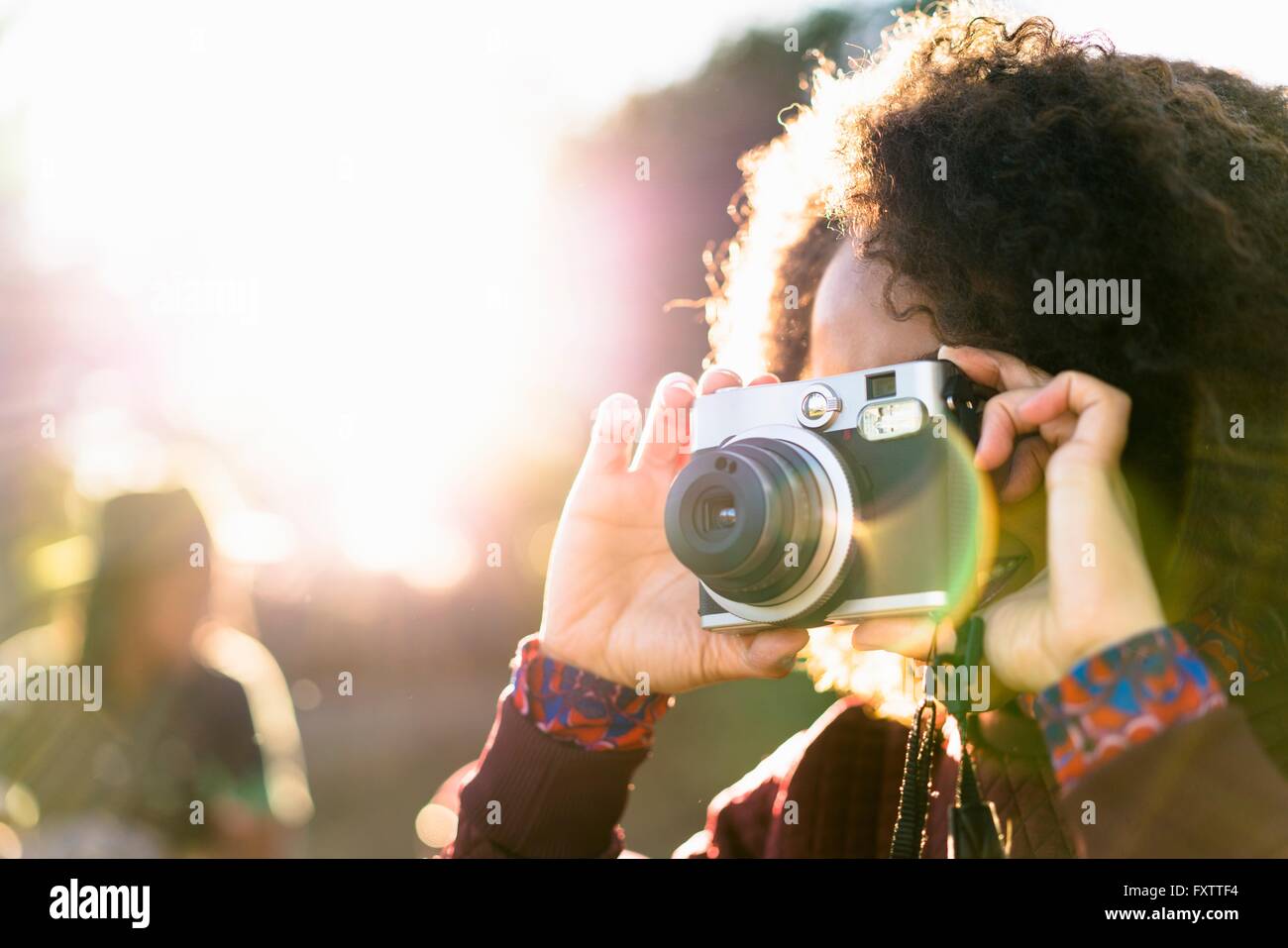 Woman taking photograph using slr camera Stock Photo - Alamy
