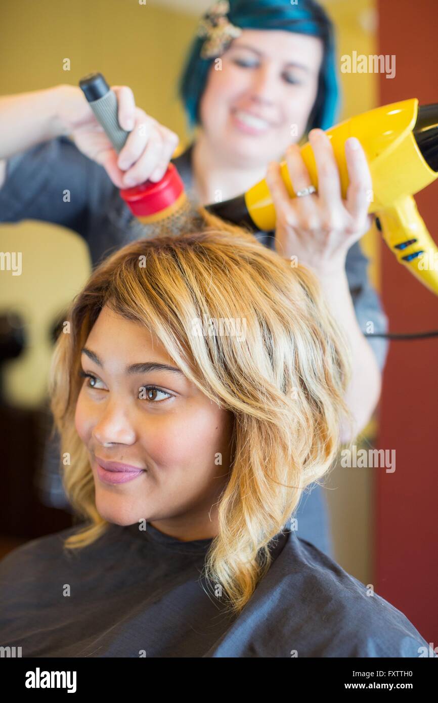 Woman drying hair in salon hi-res stock photography and images - Alamy