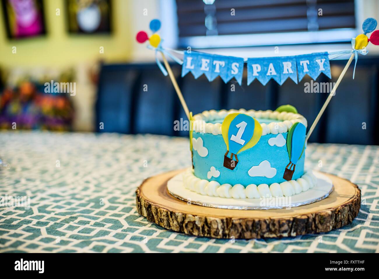 Birthday cake for first birthday party on kitchen table Stock Photo - Alamy