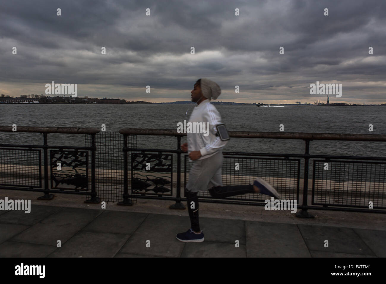 Young male runner running on riverside at dawn Stock Photo - Alamy
