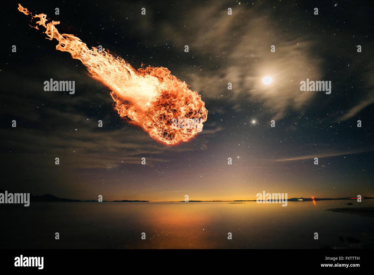 Meteor falling through starry night sky over water Stock Photo - Alamy