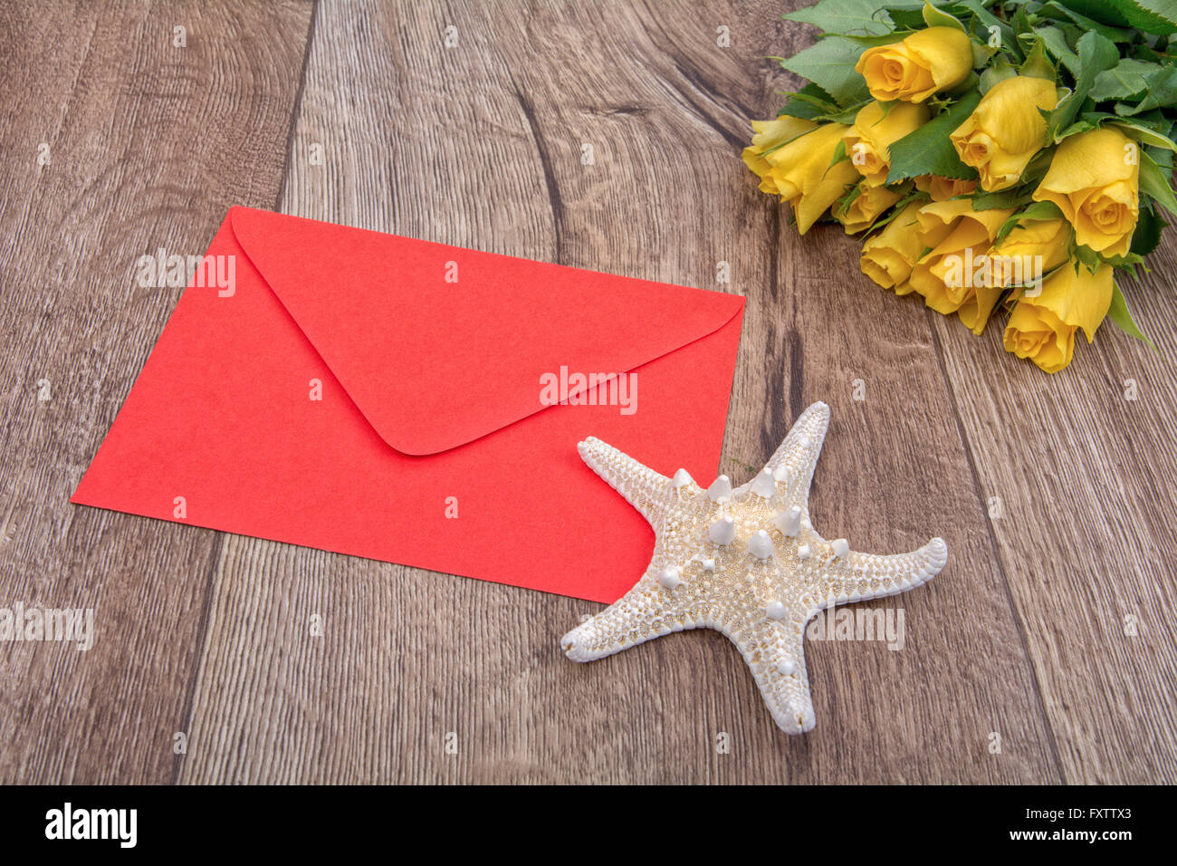 Envelope, white starfish and roses on a wooden background Stock Photo ...