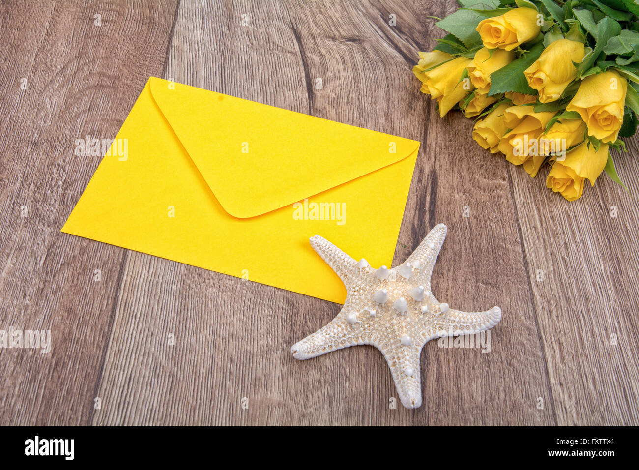 Envelope, white starfish and roses on a wooden background Stock Photo ...