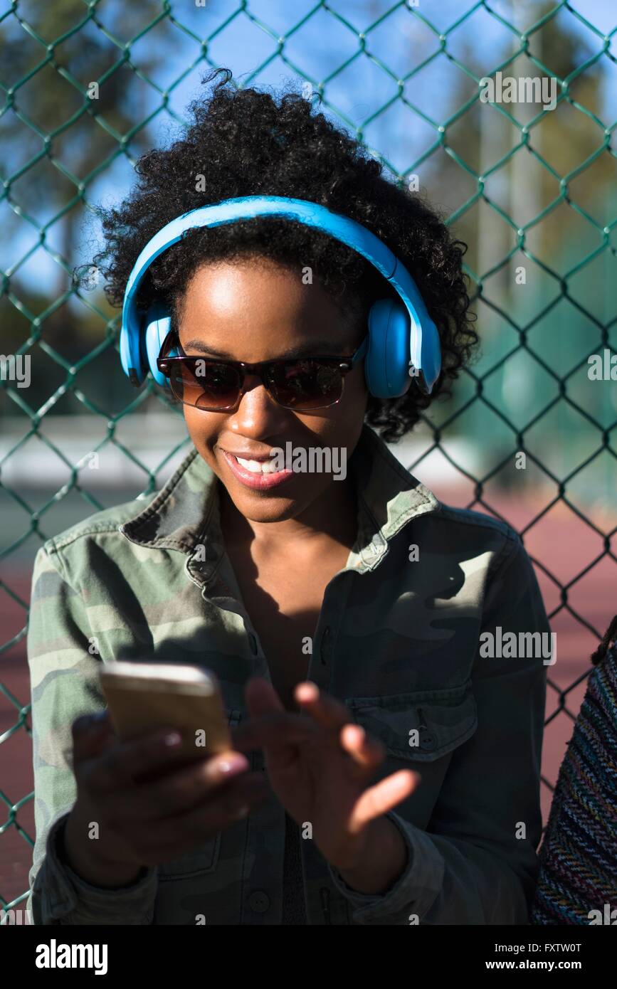 Woman wearing headphones using smartphone hi-res stock photography and ...