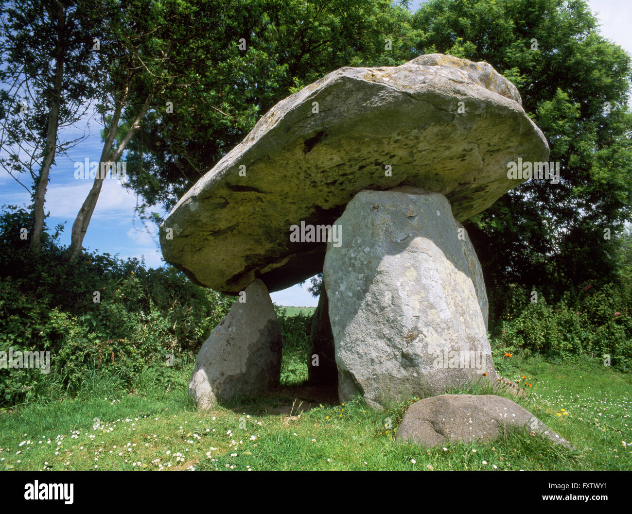 Looking NNE at the burial chamber uprights and up under the capstone of ...