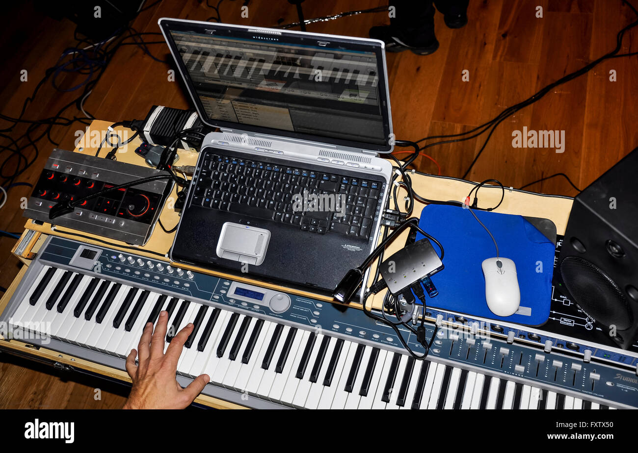 Musician playing on keyboards in a music studio Stock Photo - Alamy
