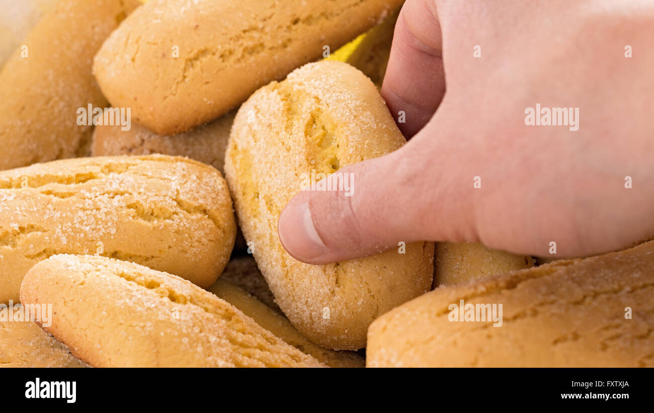 hand takes a traditional Italian biscuit Stock Photo - Alamy