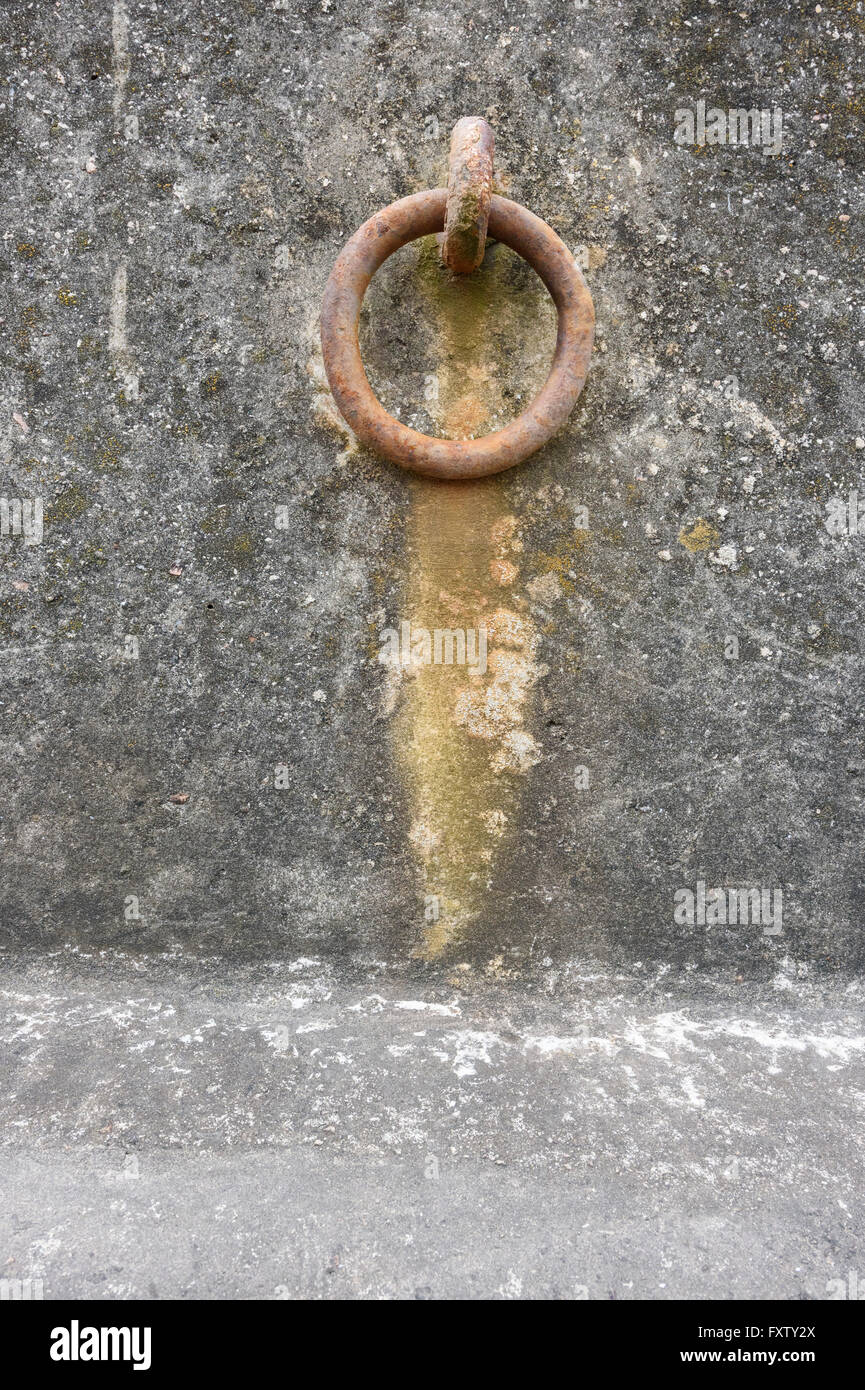 Old rusty ring embedded in the concrete sea wall in North Shore ...
