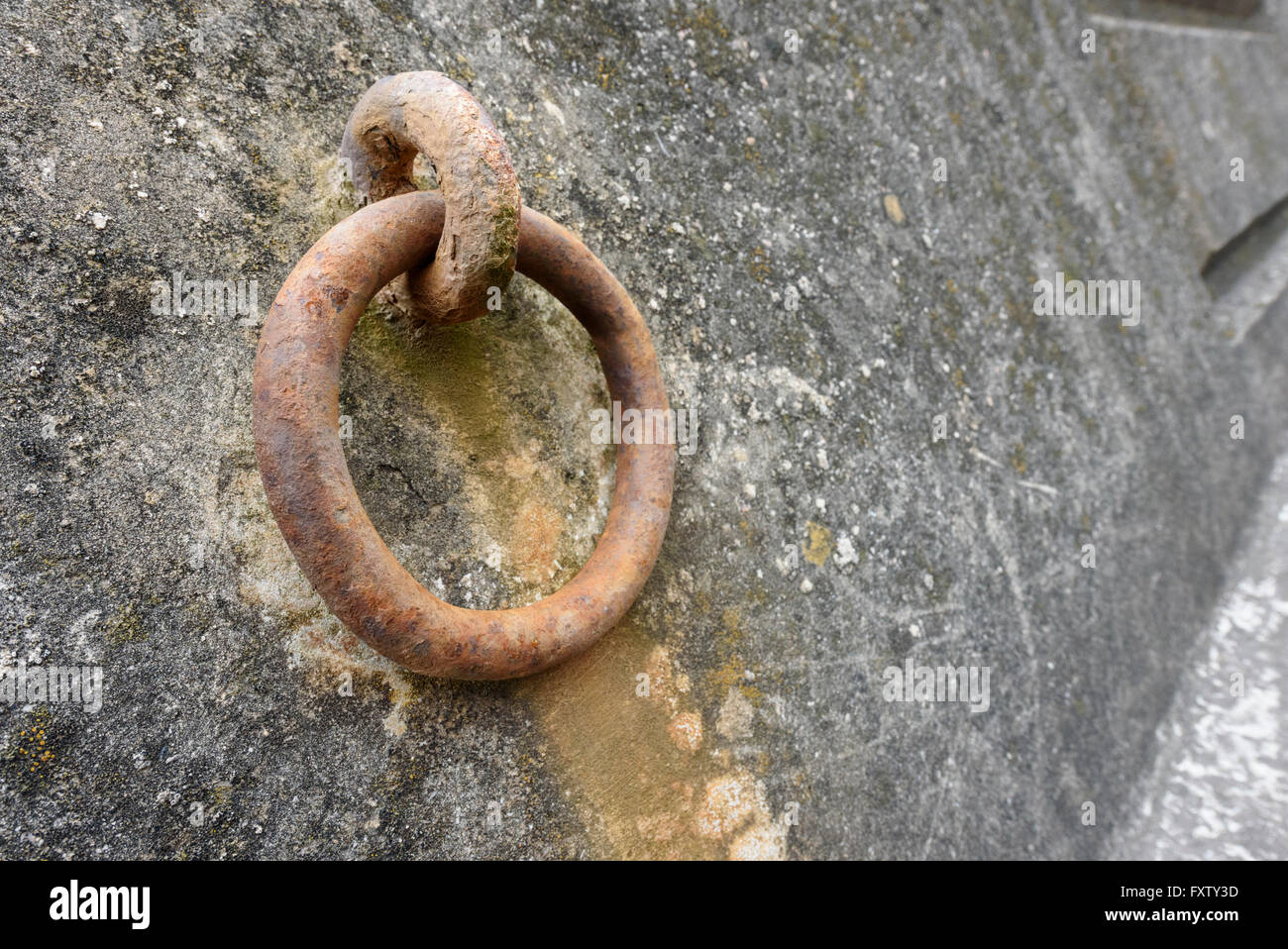 Old rusty ring embedded in the concrete sea wall in North Shore ...