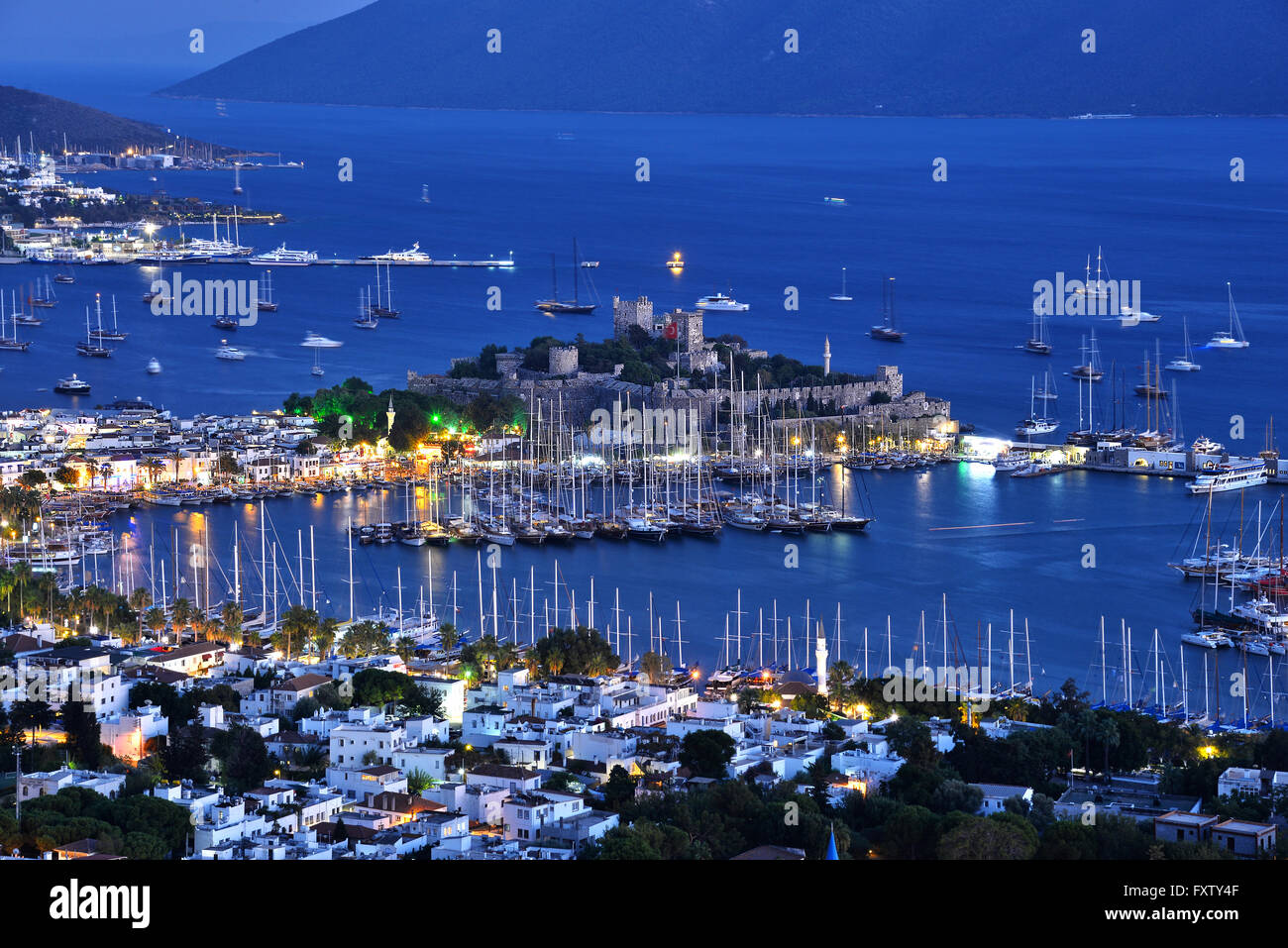 View of Bodrum harbor and Castle of St. Peter after sunset. Turkish ...