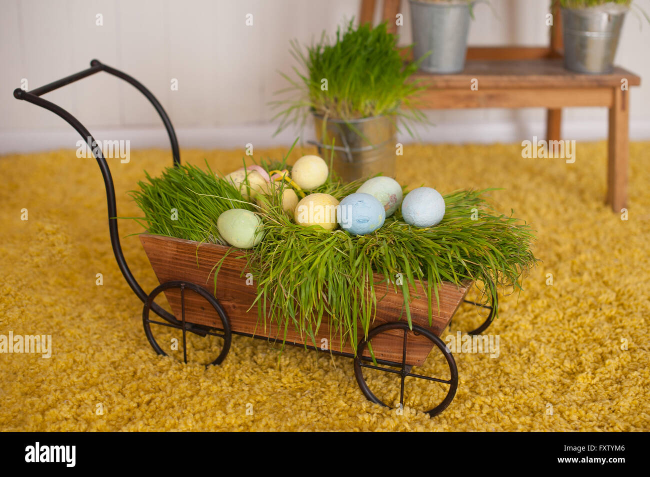 Easter eggs and colorful decor trolley in studio Stock Photo - Alamy