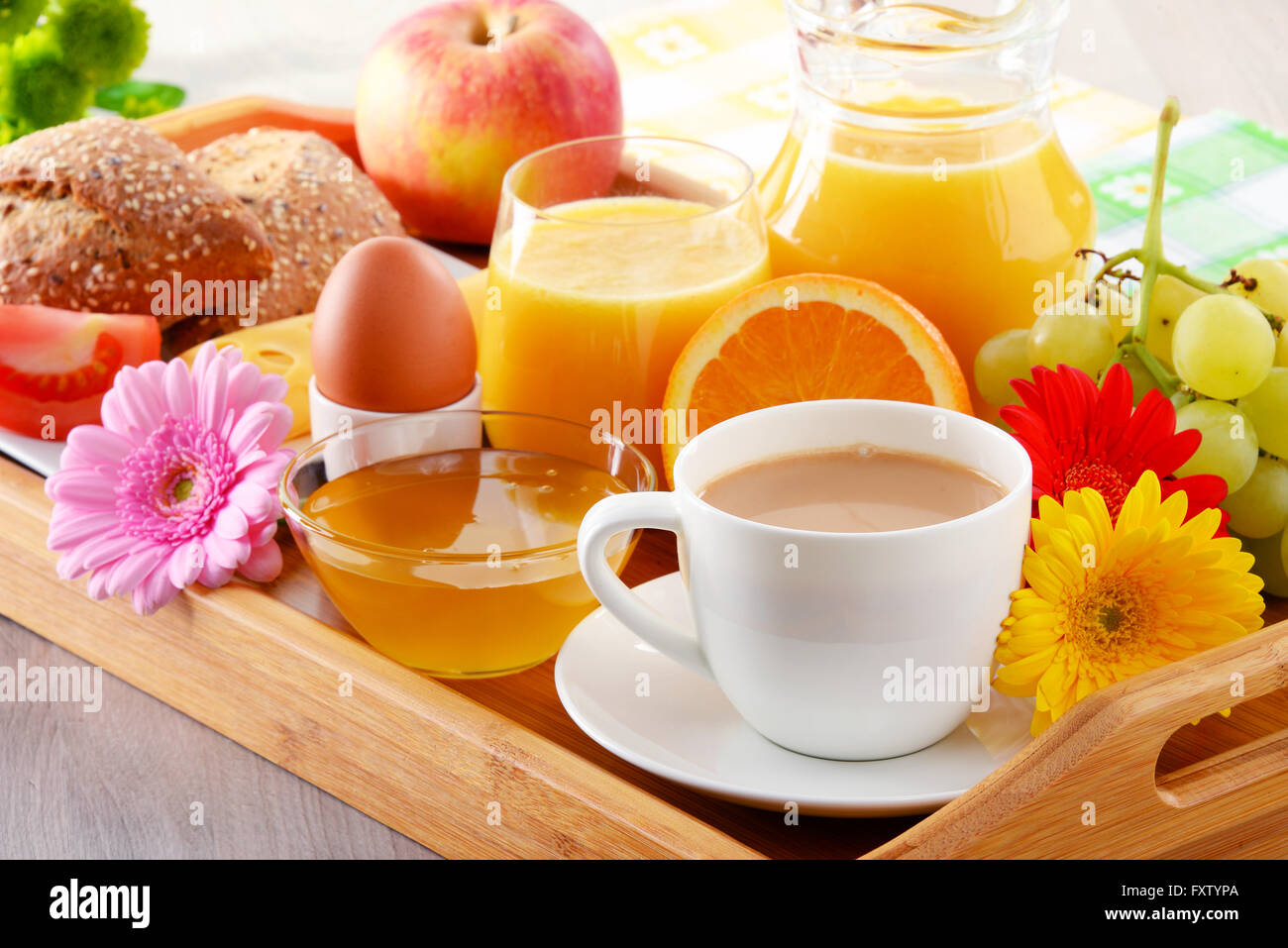 Breakfast on tray served with coffee, orange juice, egg, rolls and ...
