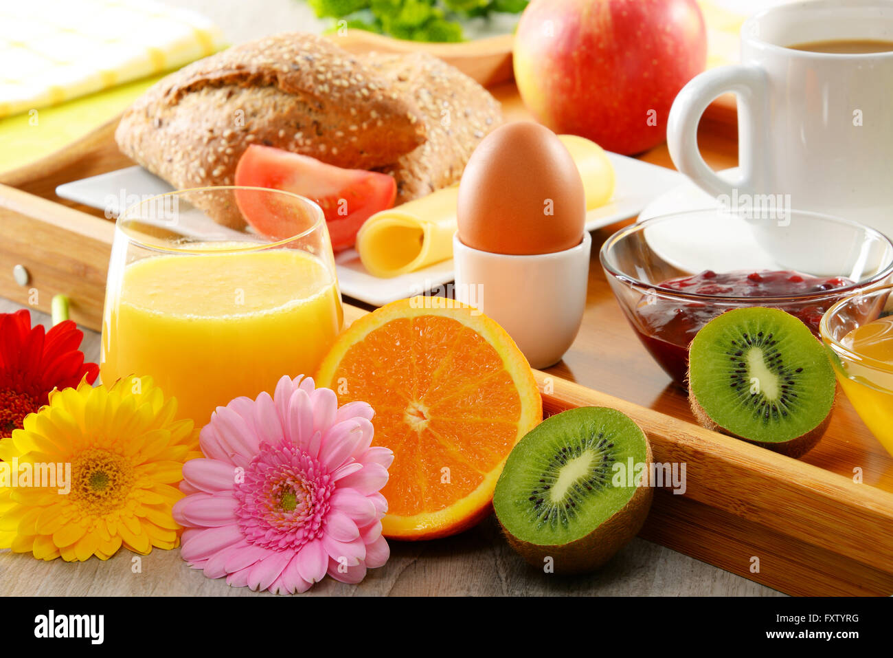 Breakfast on tray served with coffee, orange juice, egg, rolls and ...