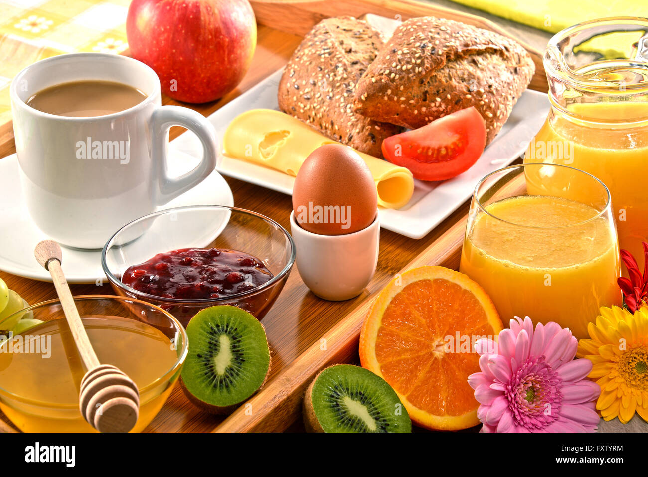 Breakfast on tray served with coffee, orange juice, egg, rolls and ...