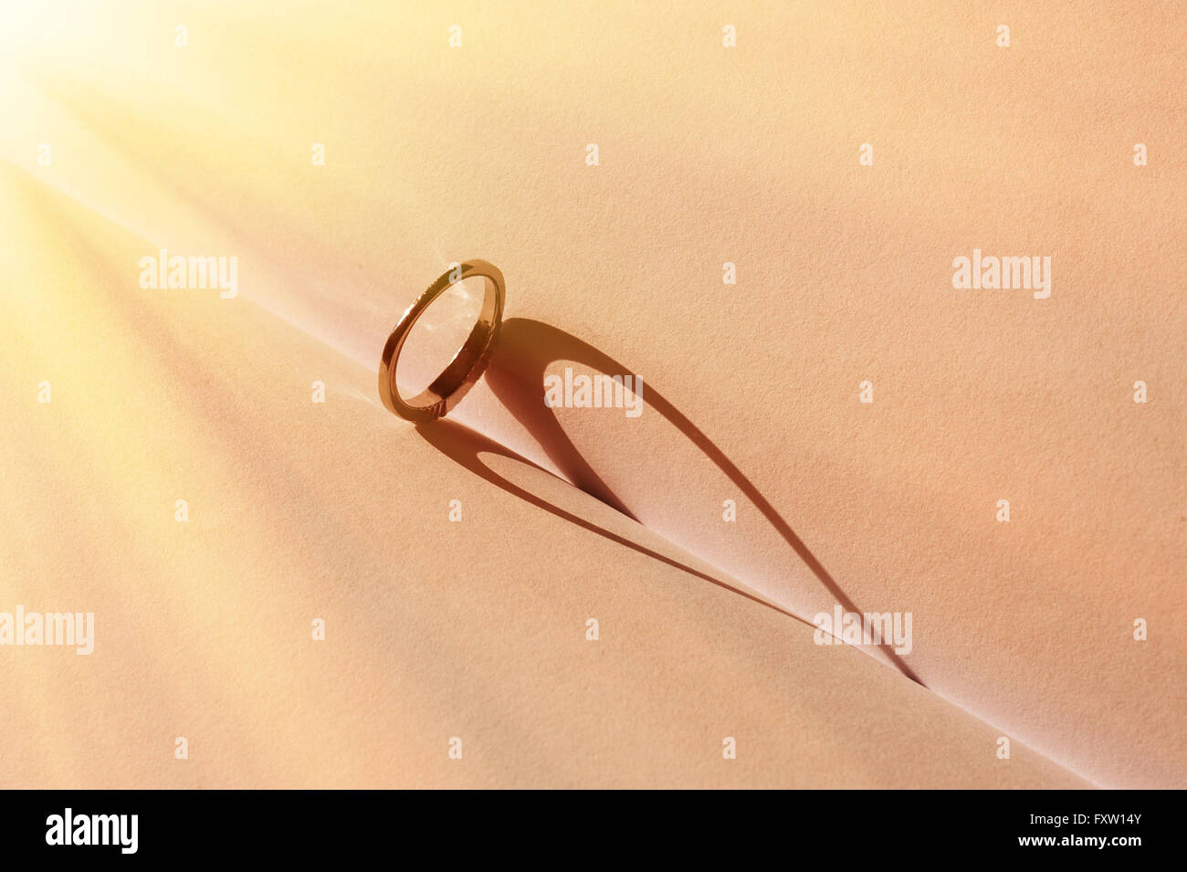 Wedding ring casting a heart-shaped shadow on the diary page Stock ...