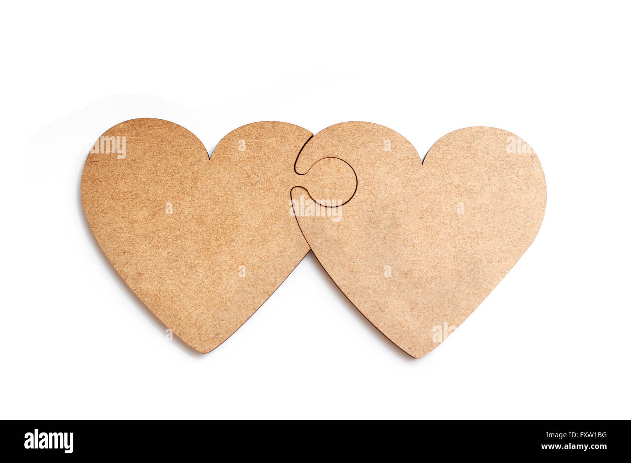 Two wooden hearts in form of puzzle on white background Stock Photo - Alamy
