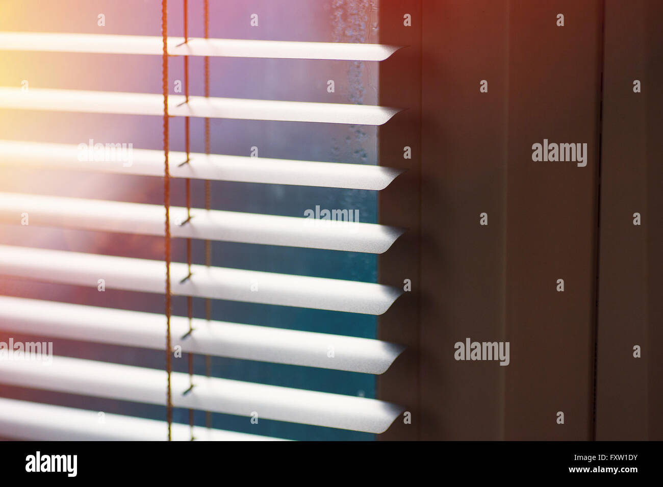Sunlight coming through venetian blinds by the window Stock Photo - Alamy