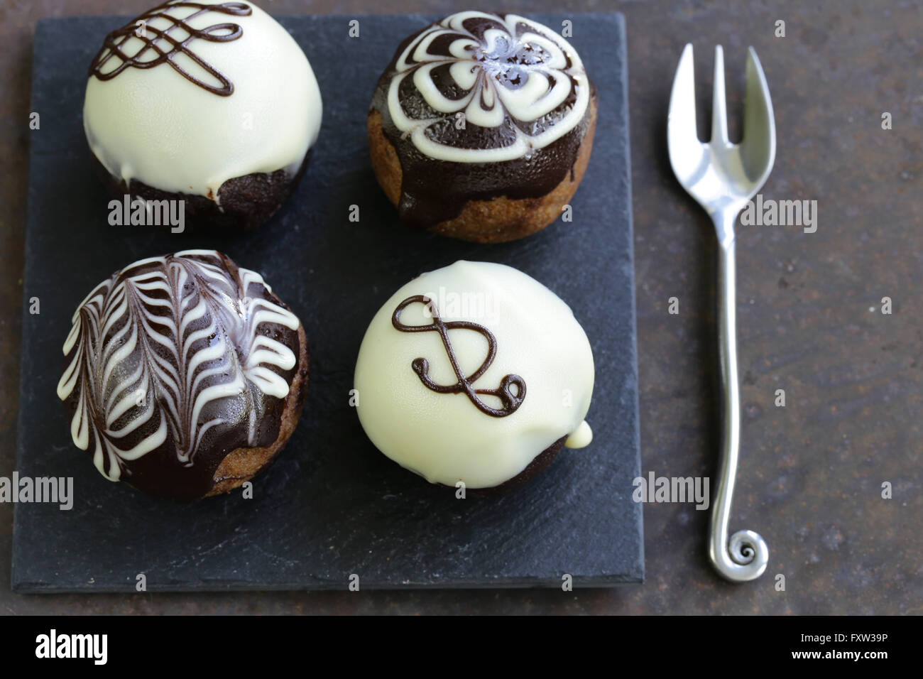 dessert biscuit balls cakes with chocolate icing Stock Photo - Alamy