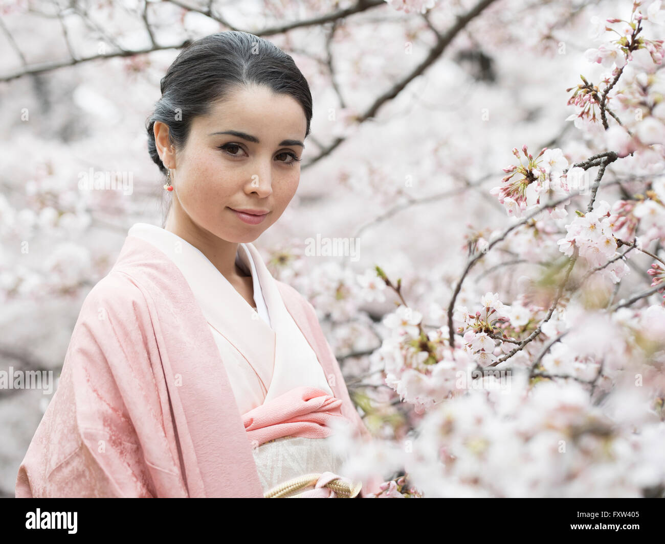 Portrait Of Young Japanese Woman Wearing Kimono With Cherry Blossom In