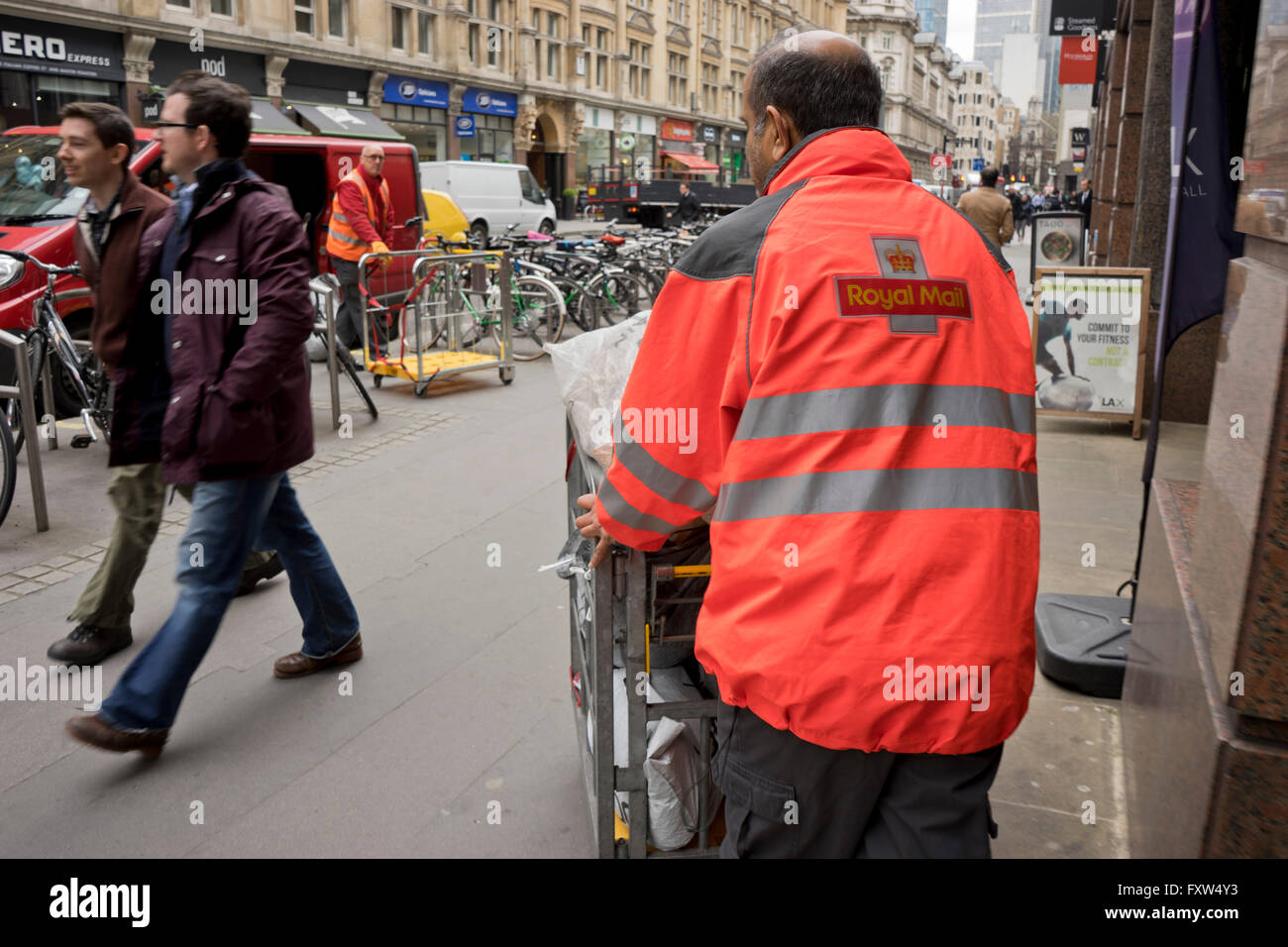 Post Office workers loading packages into van. London, England, UK ...